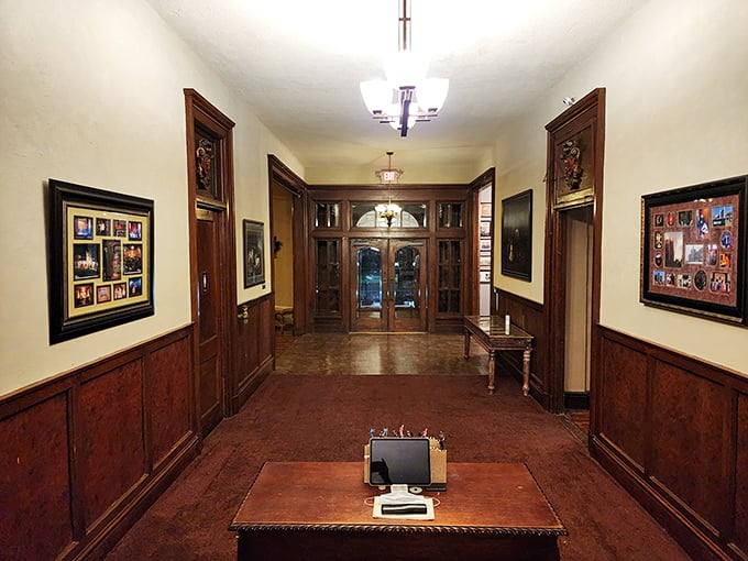 Rich wood paneling and vintage fixtures create an atmosphere of dignified elegance in the entrance hall, where history whispers from every corner.
