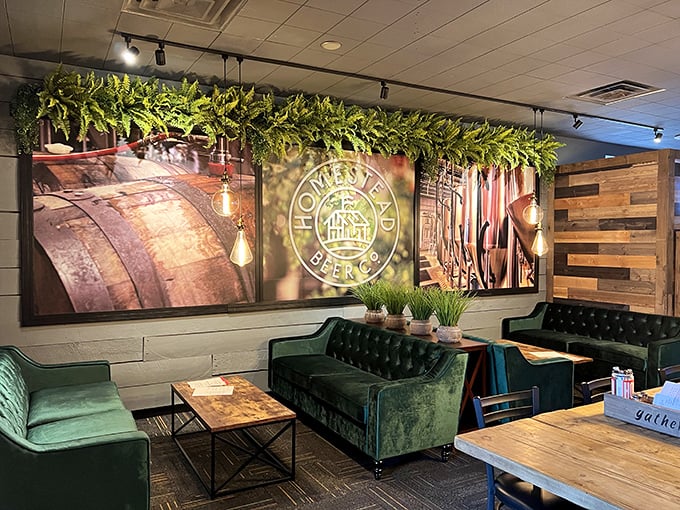 Plush emerald couches and warm wood accents create a living room vibe that says "stay awhile" &ndash; comfort food deserves comfortable seating.