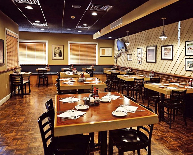 Warm wood tones and nautical touches create the perfect setting for serious seafood conversations.