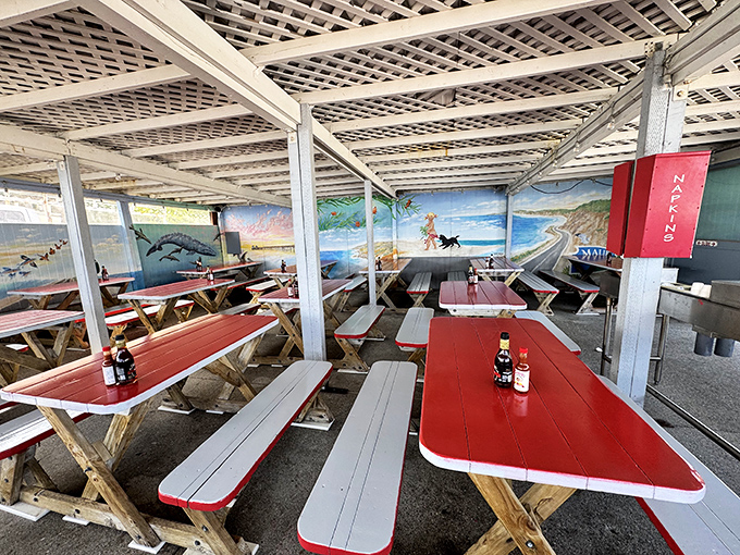 Red-topped picnic tables under a latticed roof create the perfect casual dining atmosphere. Ocean murals remind you where your lunch was swimming this morning.