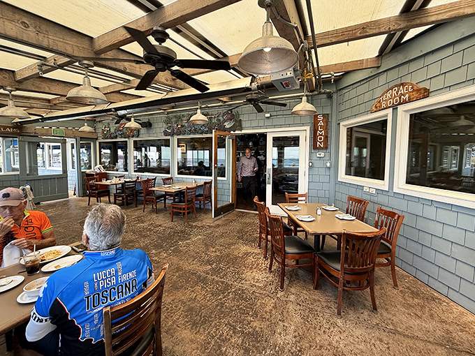 Inside the terrace room, weathered wood beams and coastal blue shingles create that perfect "I've discovered something special" atmosphere.