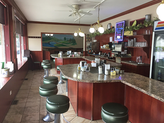 Classic diner perfection awaits at the counter, where those green vinyl stools have witnessed countless breakfast epiphanies and coffee refill miracles.