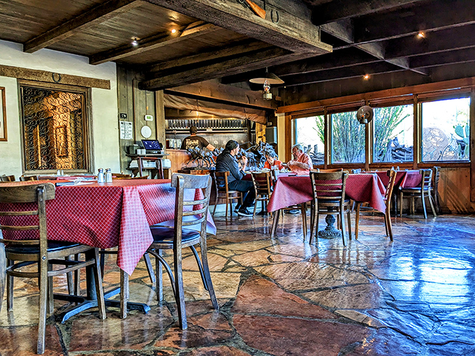 Inside, time slows down under weathered wooden beams while red checkered tablecloths promise comfort food that's about to rock your world.