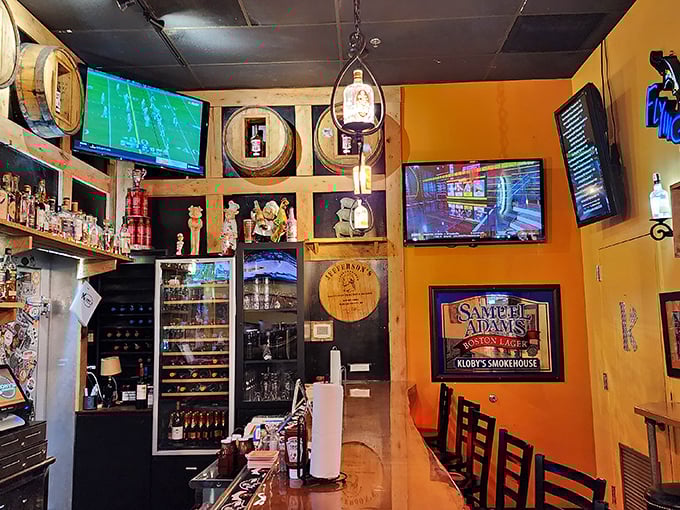 Whiskey barrels and warm wood tones create the perfect backdrop for serious barbecue contemplation. Sports on TV, spirits on shelves.