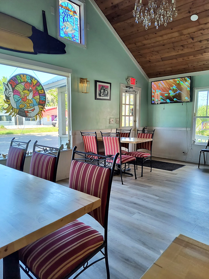 Crystal chandeliers meet mint green walls and striped chairs. This dining room feels like your eccentric aunt's Florida room&mdash;if she had impeccable taste.