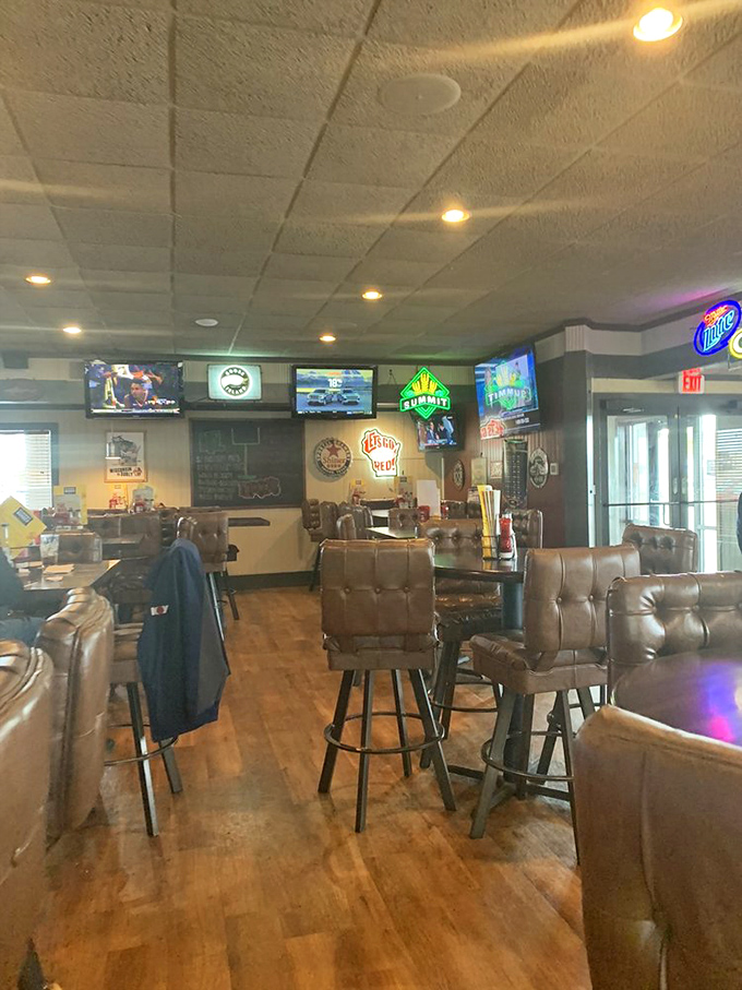Leather-backed chairs and multiple TVs create that perfect "stay awhile" vibe where important life decisions revolve around sauce choices and beer selections.