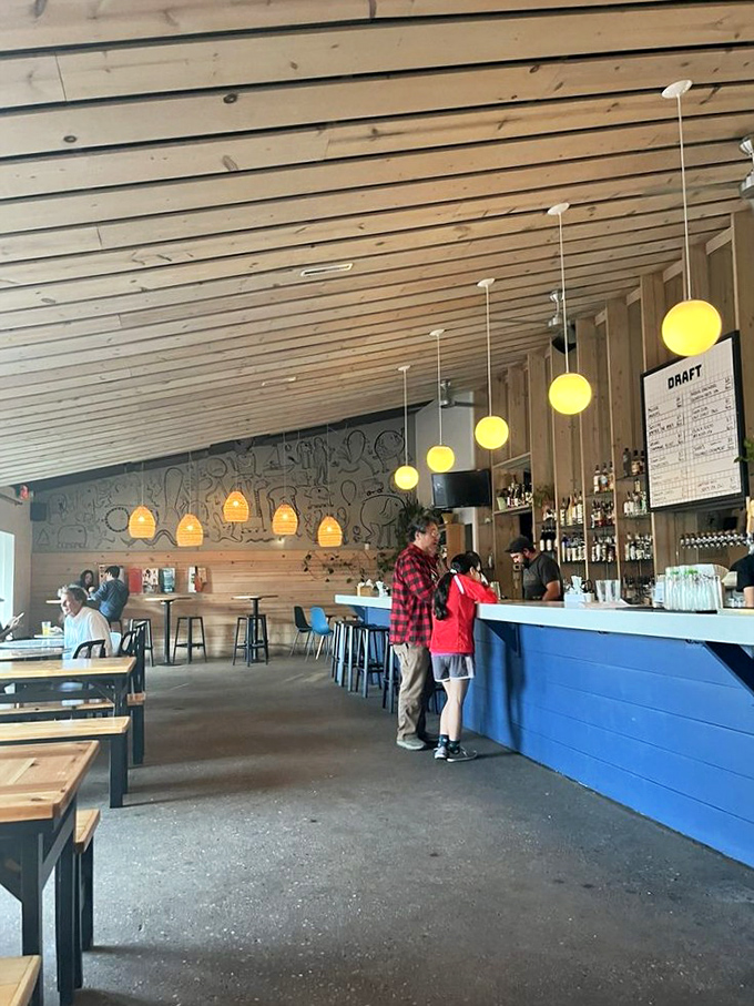 Inside, warm wooden slats and glowing pendant lights create the perfect backdrop for serious cocktail contemplation. Scandinavian minimalism meets Michigan hospitality.
