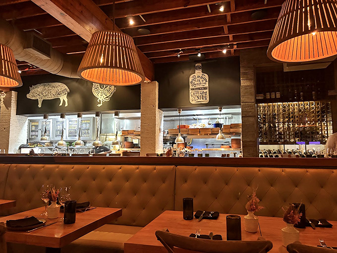 Rustic meets refined in this warm interior where wooden beams, leather banquettes, and pig silhouettes create Southern charm with big-city polish.