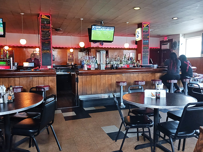 Warm wood paneling, classic bar stools, and checkered floors create that perfect neighborhood joint vibe. The kind of place where everybody might not know your name&mdash;yet.