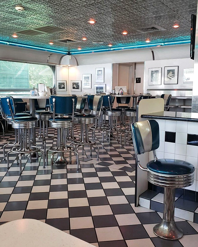 Step inside this time machine where turquoise dreams and checkerboard floors create the perfect breakfast backdrop.