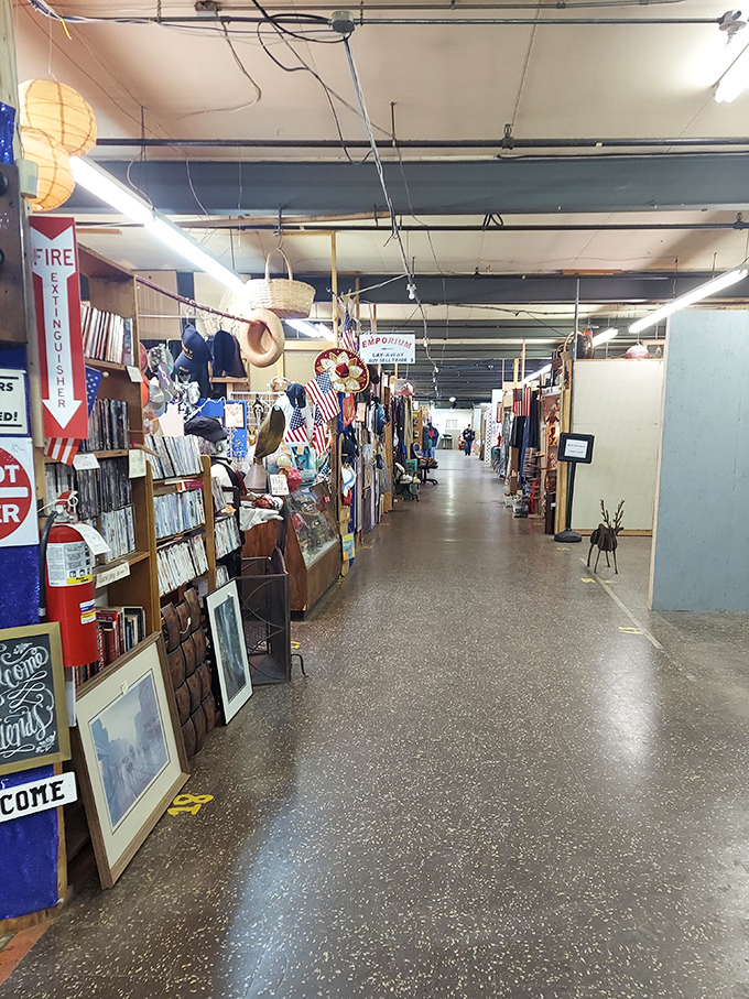 Rows of vendor booths filled with books, clothes, flags, hats, and various collectibles.