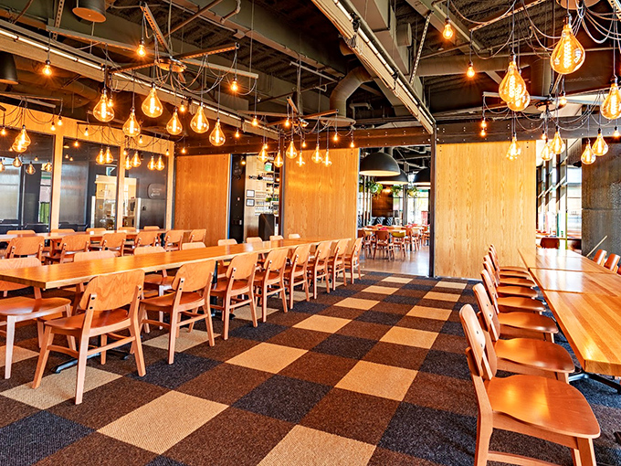 Edison bulbs cast a warm glow over wooden tables while the checkered floor adds playful charm. It's coastal chic meets Midwest hospitality in the most delicious way possible.