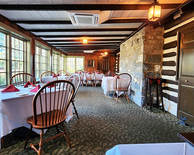History meets hospitality in this dining room where exposed log walls and Windsor chairs create the perfect backdrop for memorable meals and conversations.
