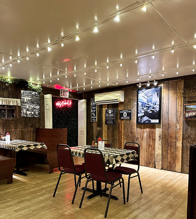 String lights dance across wooden walls in this cozy dining room, where checkered tablecloths and nostalgic decor create the perfect backdrop for sandwich bliss.