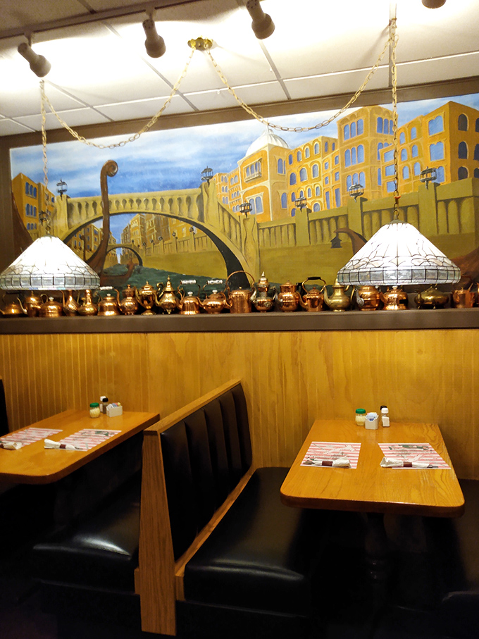 Inside, copper teapots gleam beneath a mural of Italian vistas. These wooden booths have witnessed countless first dates, family celebrations, and "I-can't-believe-I-ate-the-whole-thing" moments.