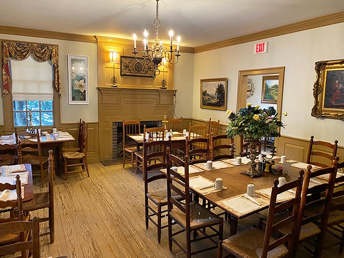 Colonial charm meets comfort in this dining room where history and hunger happily coexist. The fireplace has witnessed countless satisfied sighs.