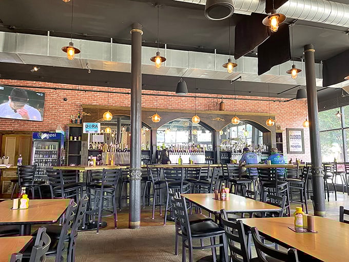 Industrial-chic meets comfort in this thoughtfully designed space. Exposed brick walls, pendant lighting, and those sturdy columns create the perfect backdrop for burger-induced happiness.