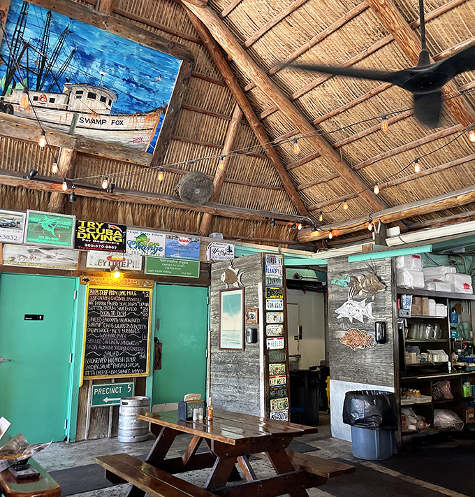 Beneath the rustic tiki ceiling, license plates and fishing memorabilia tell stories of the sea while string lights create the perfect "I've discovered something special" ambiance.
