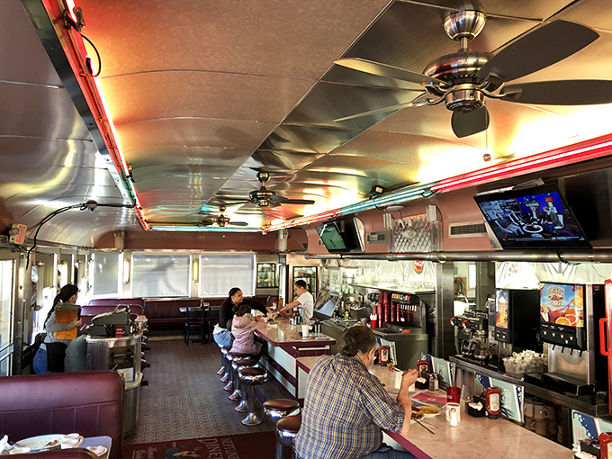 Inside Neptune Diner, chrome meets comfort as ceiling fans lazily spin above diners enjoying that perfect balance of conversation and calories.