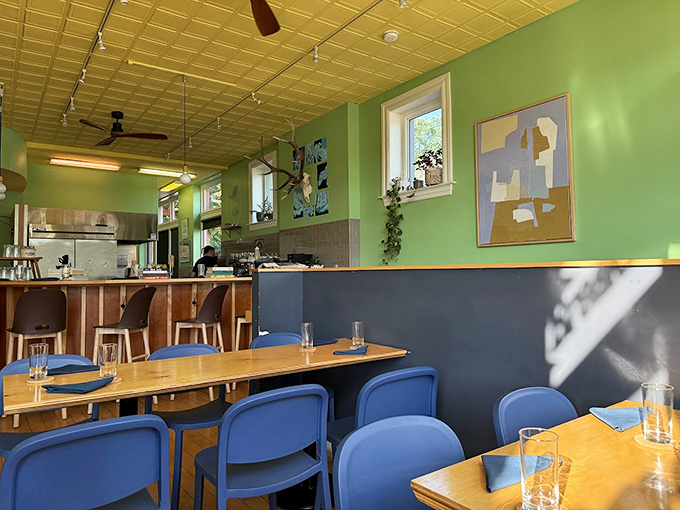 The mint-green walls and blue chairs create a space that feels both trendy and timeless&mdash;like your coolest friend's apartment, if that friend could cook brilliantly.