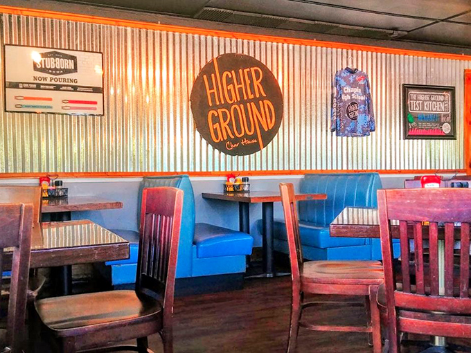 Blue booths that pop against corrugated metal walls create that perfect "industrial cozy" vibe that makes you want to settle in for the afternoon.