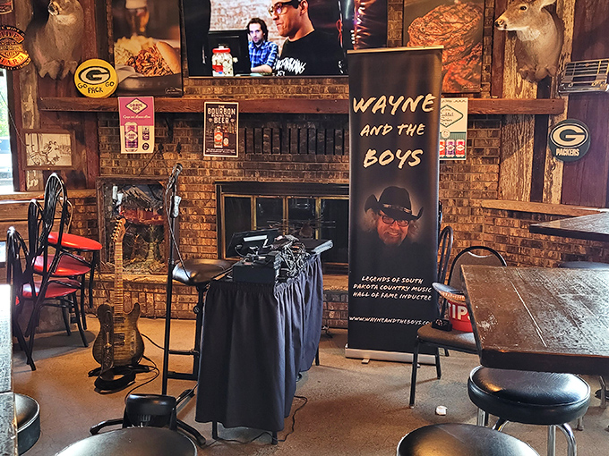 Inside, rustic charm meets sports bar energy. Green Bay Packers memorabilia and mounted trophies create that perfect "welcome home" vibe every great BBQ joint needs.