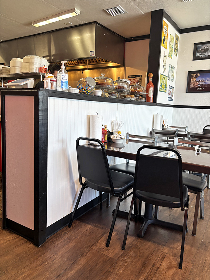 Classic diner aesthetics with those unmistakable black chairs and white wainscoting&mdash;where comfort begins before you even taste the food.