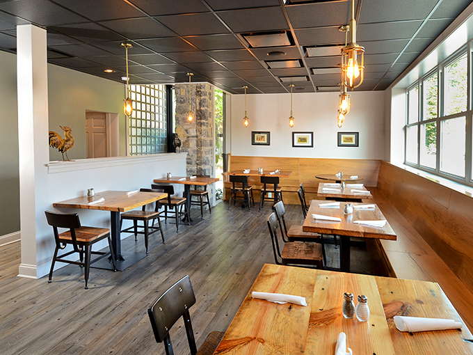 Edison bulbs cast a warm glow over handcrafted wooden tables, creating that perfect balance of rustic charm and modern comfort &ndash; like a BBQ joint designed by someone who actually enjoys eating.