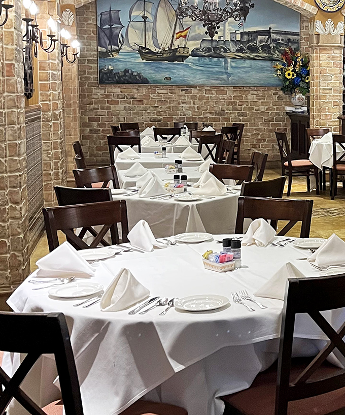Crisp white tablecloths against exposed brick walls create an atmosphere where old-world charm meets impeccable dining standards. Like stepping into a European postcard!