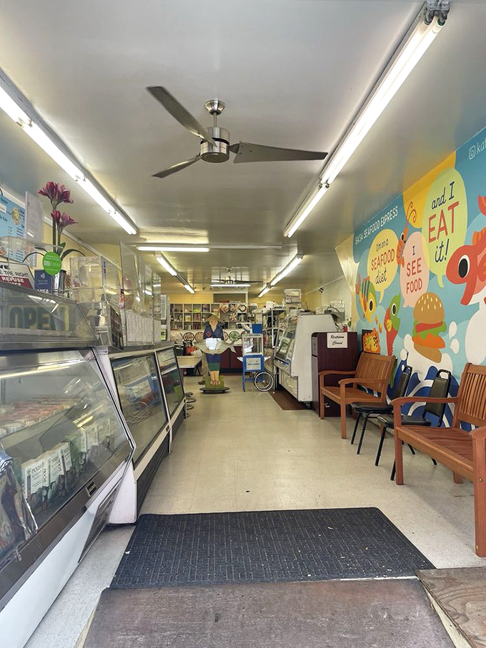 Inside, fluorescent lights illuminate a no-frills interior where the colorful "SEE it and EAT it!" mural reminds you this place is about substance over style.