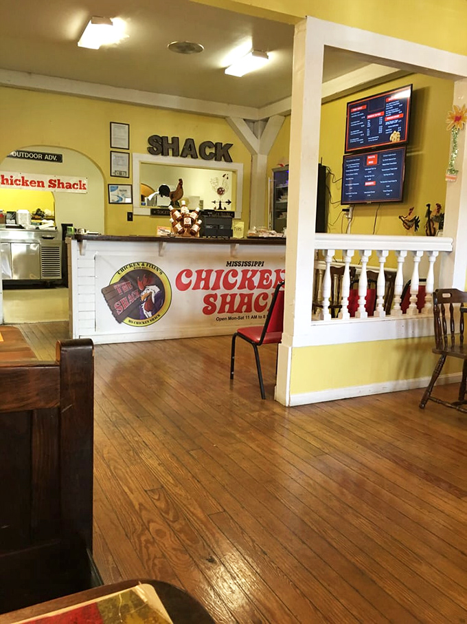 Warm yellow walls and wooden floors create that "grandma's house" feeling. The dining area's homey charm instantly signals you're in for authentic comfort.