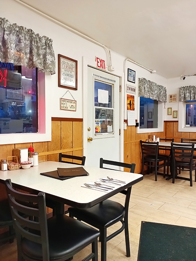Classic diner charm at its finest&mdash;wood paneling, simple tables, and those floral curtains your grandmother would absolutely approve of.