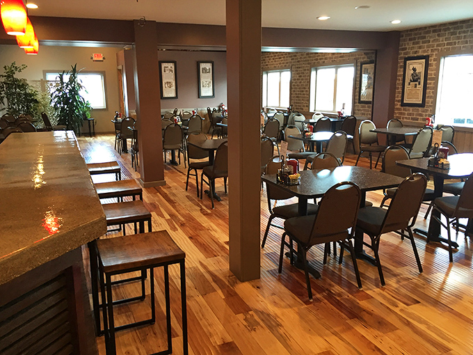 Warm wood floors, exposed brick, and perfectly spaced tables create that rare atmosphere where strangers become temporary neighbors over coffee.