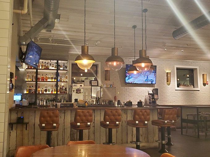 The bar area blends industrial chic with Texas warmth&mdash;leather stools practically begging you to settle in for a post-brisket bourbon.