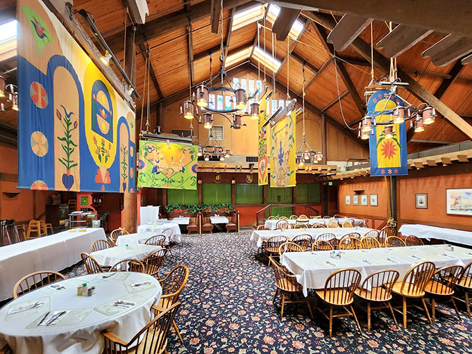 Step inside to discover soaring wooden beams, colorful folk-art banners, and a dining room that feels like a cozy Danish great hall.