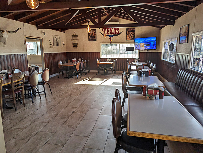 Wooden wainscoting, exposed beams, and Texas d&eacute;cor create that perfect "focus-on-the-food" atmosphere where napkins aren't optional but a strategic necessity.