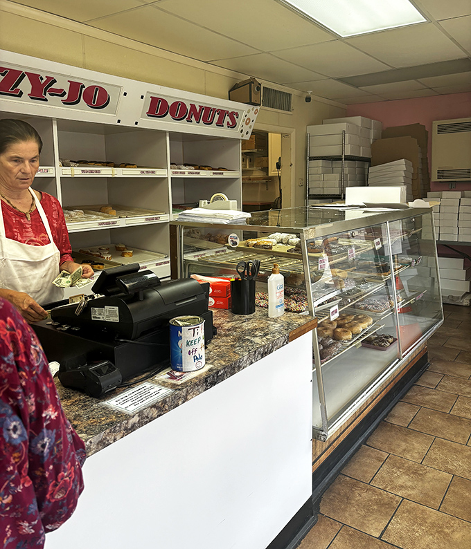Behind the counter, where donut dreams come true. This no-frills setup focuses on what matters&mdash;getting fresh pastries into eager hands.
