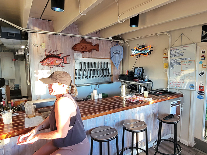 Behind the bar, wooden fish art watches over patrons while beer taps stand ready. This isn't decoration—it's a mission statement.