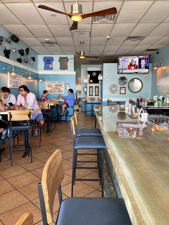 Inside Hurricane Hanks, coastal blue walls and that "Go Home Irma You're Drunk" sign tell you this place has weathered storms with humor intact.