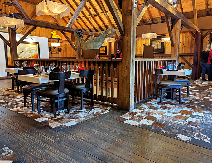 Timber-framed heaven where century-old barn beams create intimate dining nooks. The cowhide floor tiles are a cheeky nod to what's on the menu.