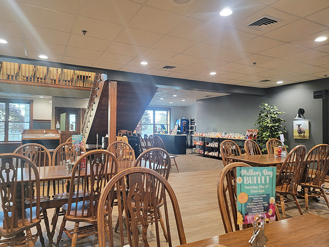 Windsor-back chairs await hungry patrons in a dining room where simplicity meets comfort. The warm wood tones promise a meal that's anything but plain.