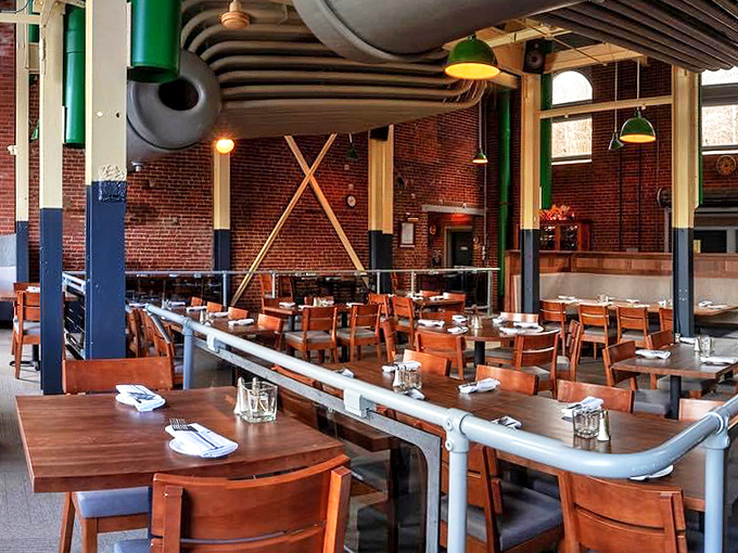 Industrial chic meets dining elegance where exposed pipes and brick walls create atmosphere as rich as the menu offerings.
