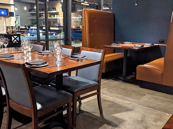 Leather booths and polished wood tables create an atmosphere that whispers "special occasion" while still saying "come as you are."