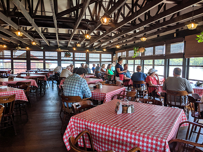 Red and white checkered tablecloths set the stage for seafood drama, where conversations flow as freely as the harbor views through panoramic windows.