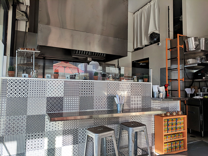 Bright red walls and modern lighting create an atmosphere where comfort meets cool&mdash;like your favorite jeans paired with a new jacket.