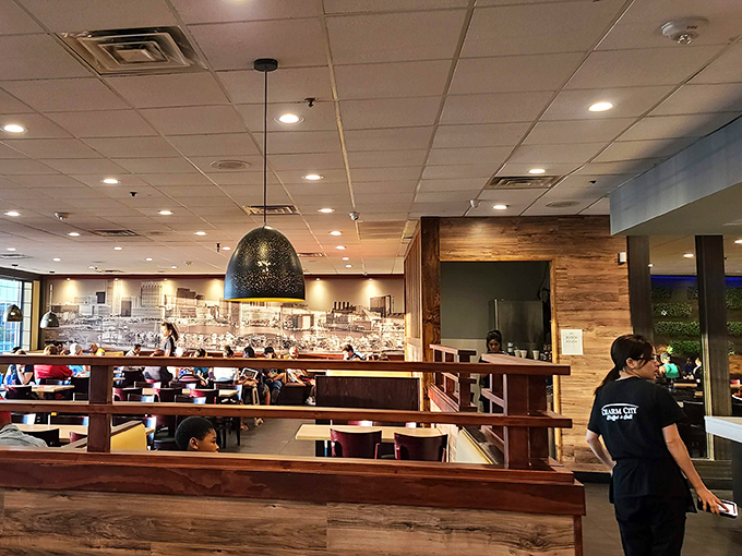 Modern meets cozy in this thoughtfully designed dining space, where warm wood accents and strategic lighting create the perfect backdrop for your impending food coma.