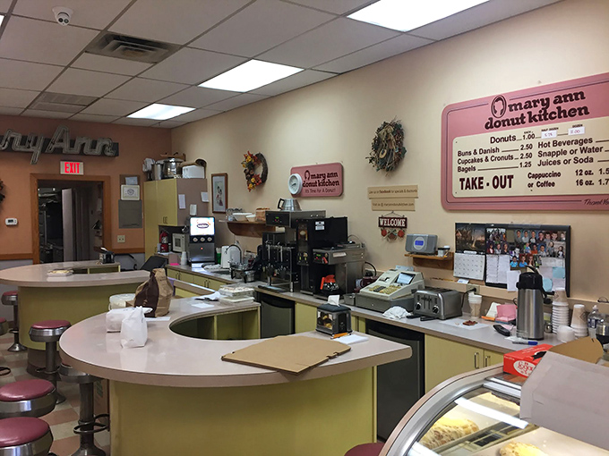 Retro charm meets donut paradise at this vintage counter. The pink and yellow color scheme isn't just decoration&mdash;it's a warning sign for impending joy.