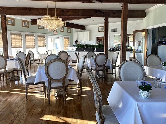 Sunlight dances across polished wood floors while elegant chairs await diners seeking both refinement and relaxation&mdash;no jacket required, just an appetite.