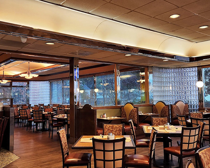 Inside, the warm wood paneling and comfortable booths create that perfect diner atmosphere where conversations flow as freely as the coffee.