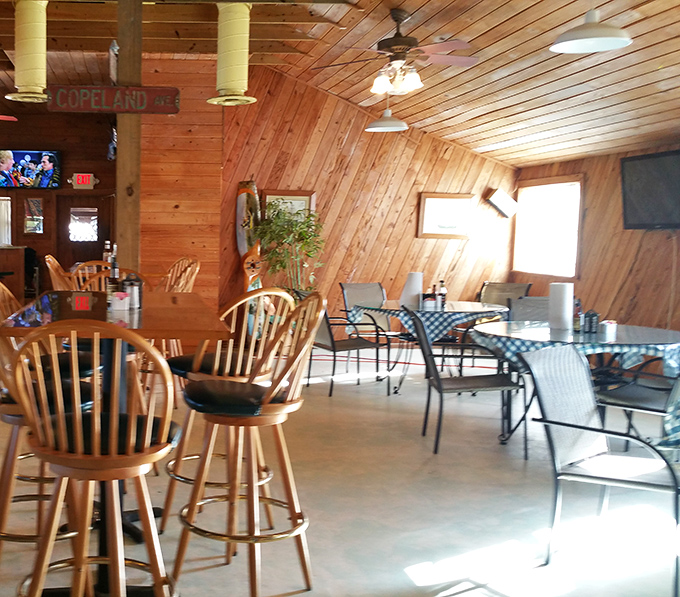 Wood paneling and ceiling fans create the perfect "Florida fishing lodge meets your uncle's basement" aesthetic that somehow just works.